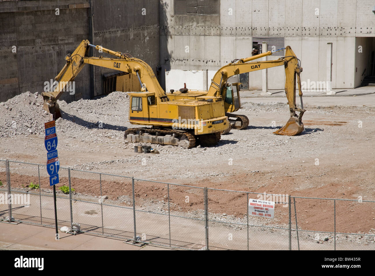 Two backhoes in an empty construction site Stock Photo - Alamy