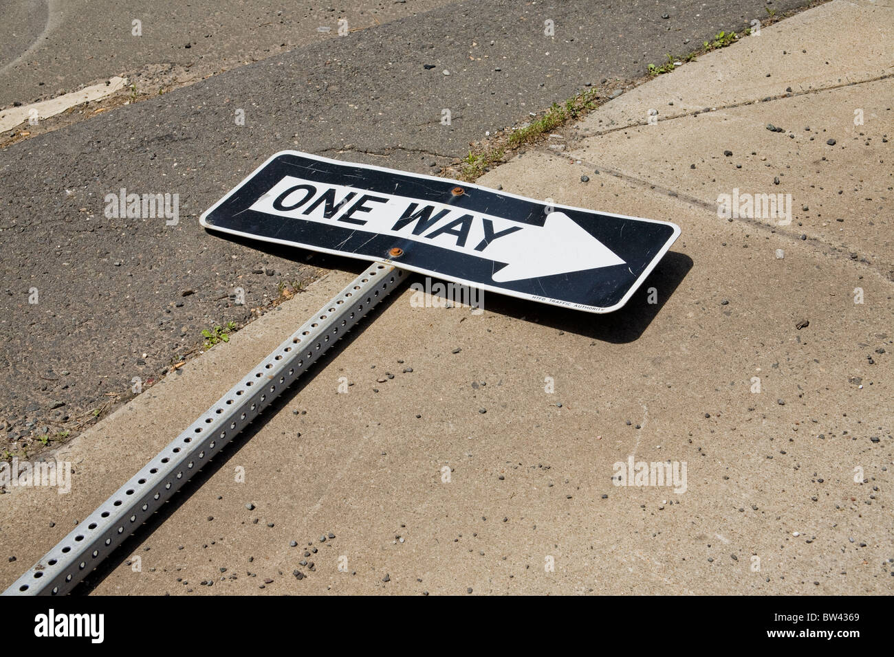 One Way traffic sign laying on the ground Stock Photo - Alamy