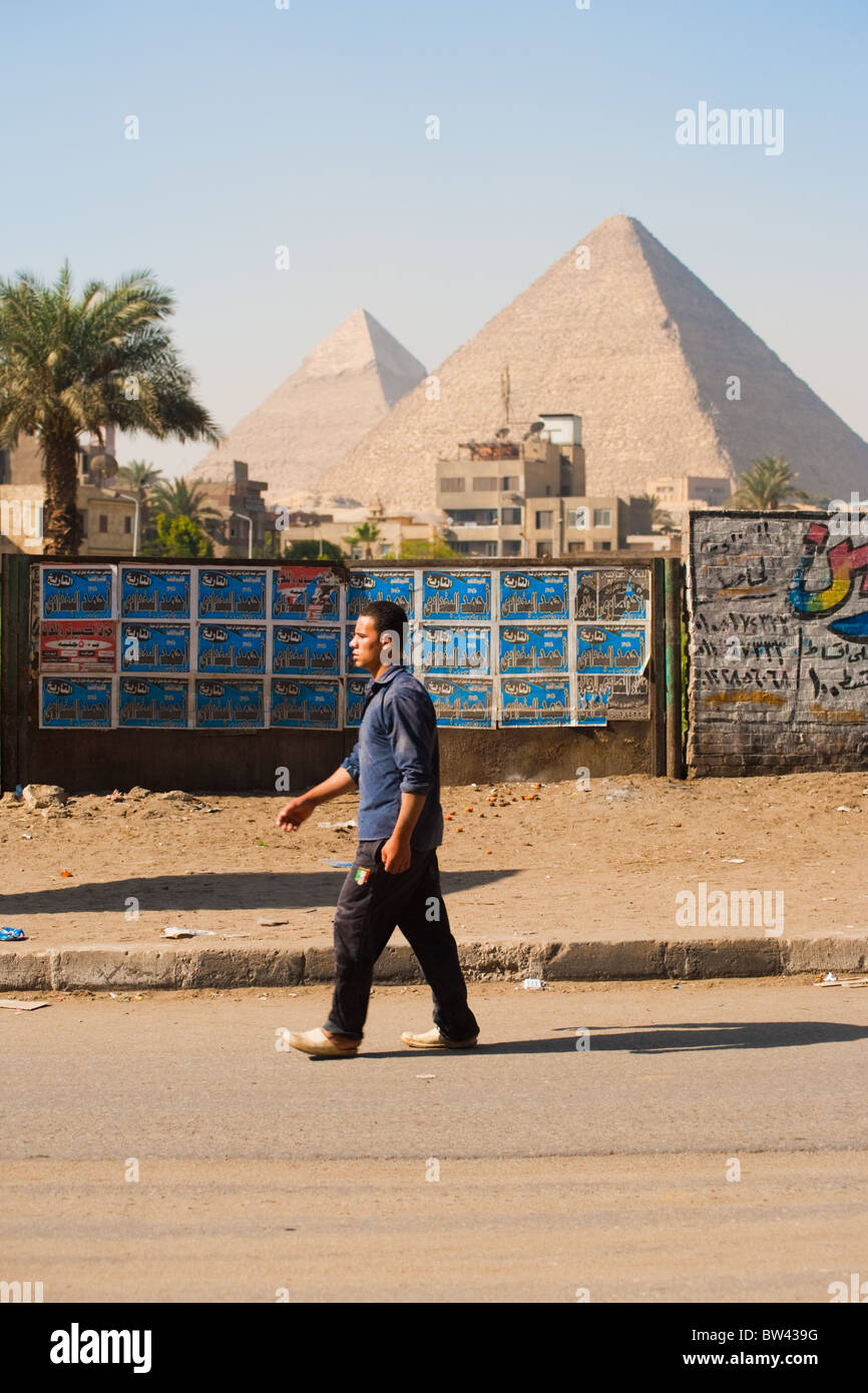 An Egyptian resident of Giza walks on a road near the Pyramids of Giza ...
