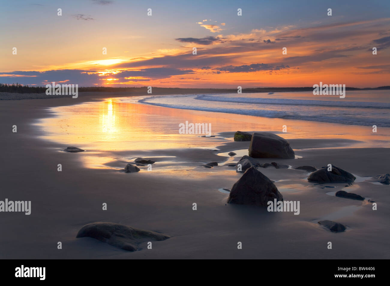 Sunrise on a beach near the Port Bickerton Lighthouse, eastern shore of ...