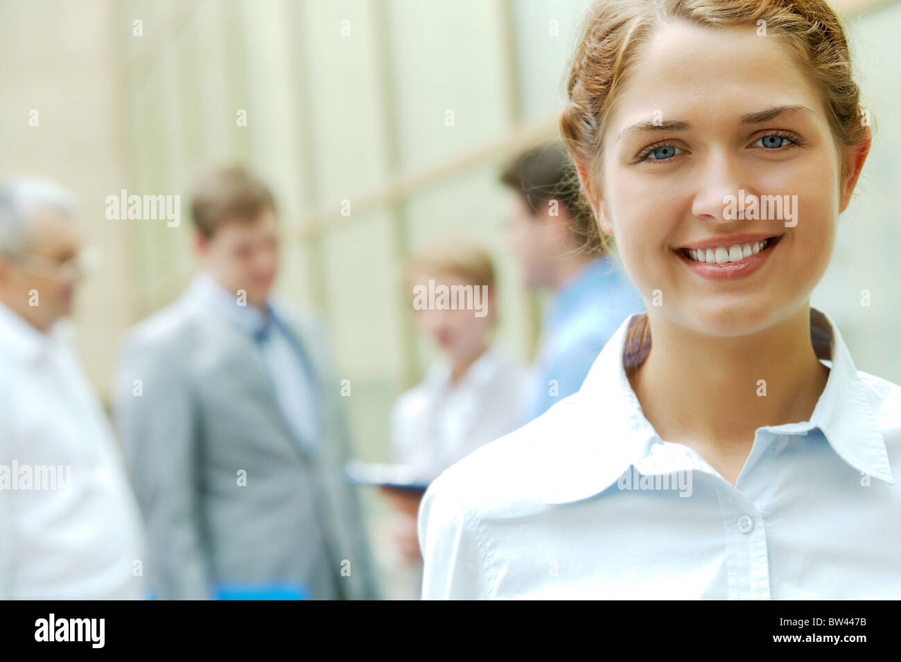 Portrait of pretty leader smiling at camera in natural environment ...