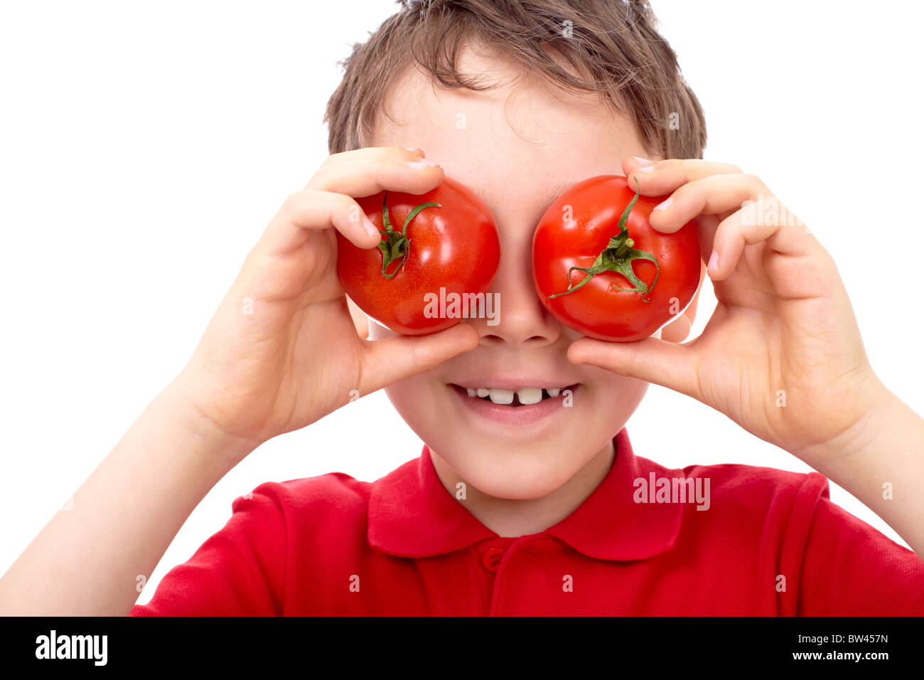 Portrait of happy boy with ripe tomatoes before his eyes Stock Photo ...