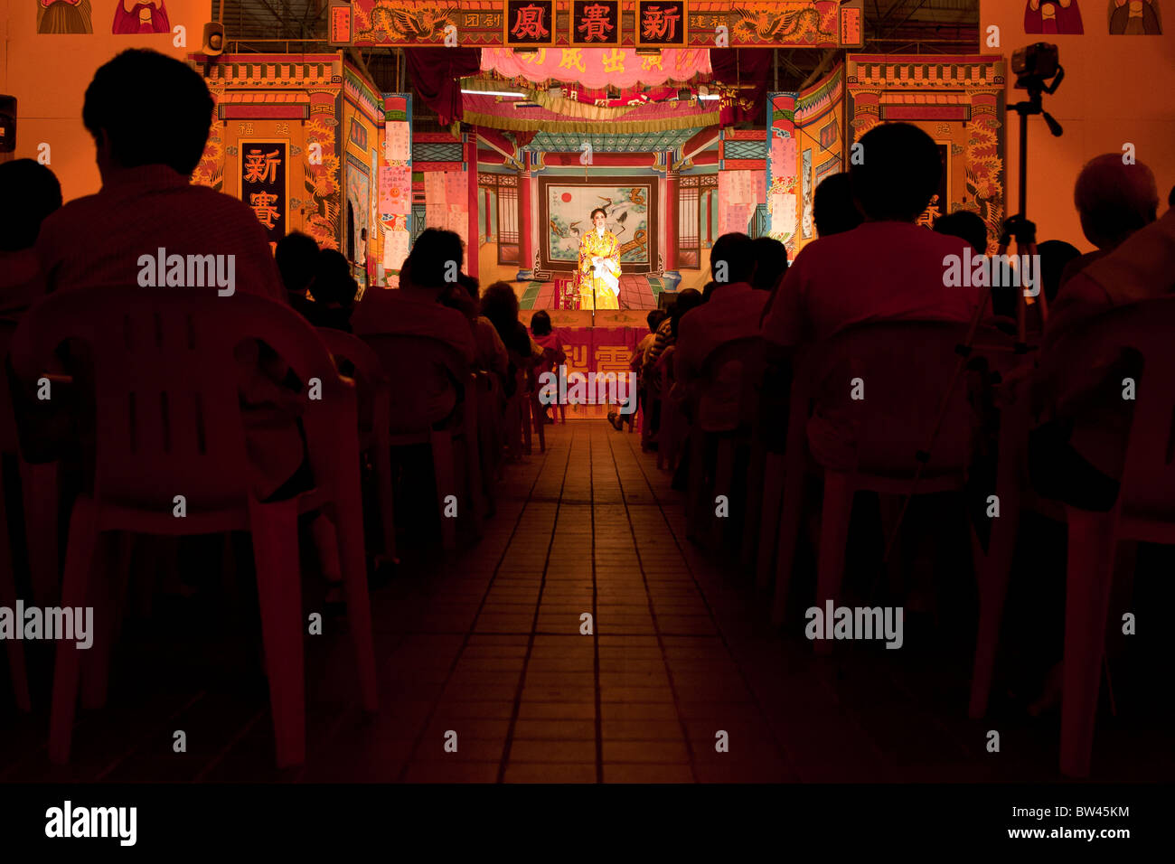 Members of the audience watch a performance by the Sing Sai Hong troupe ...