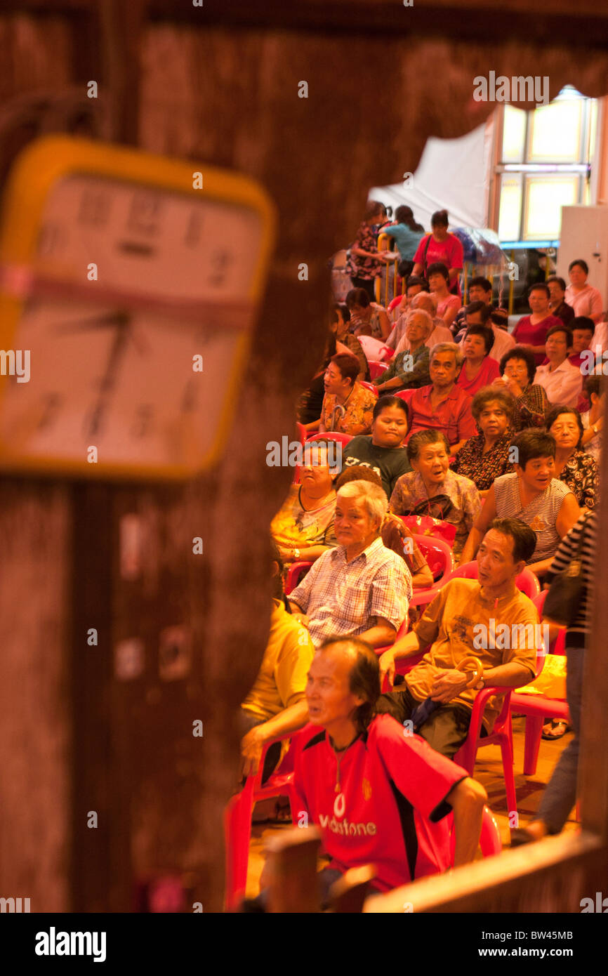 Members of the audience watch a performance by the Sing Sai Hong troupe ...