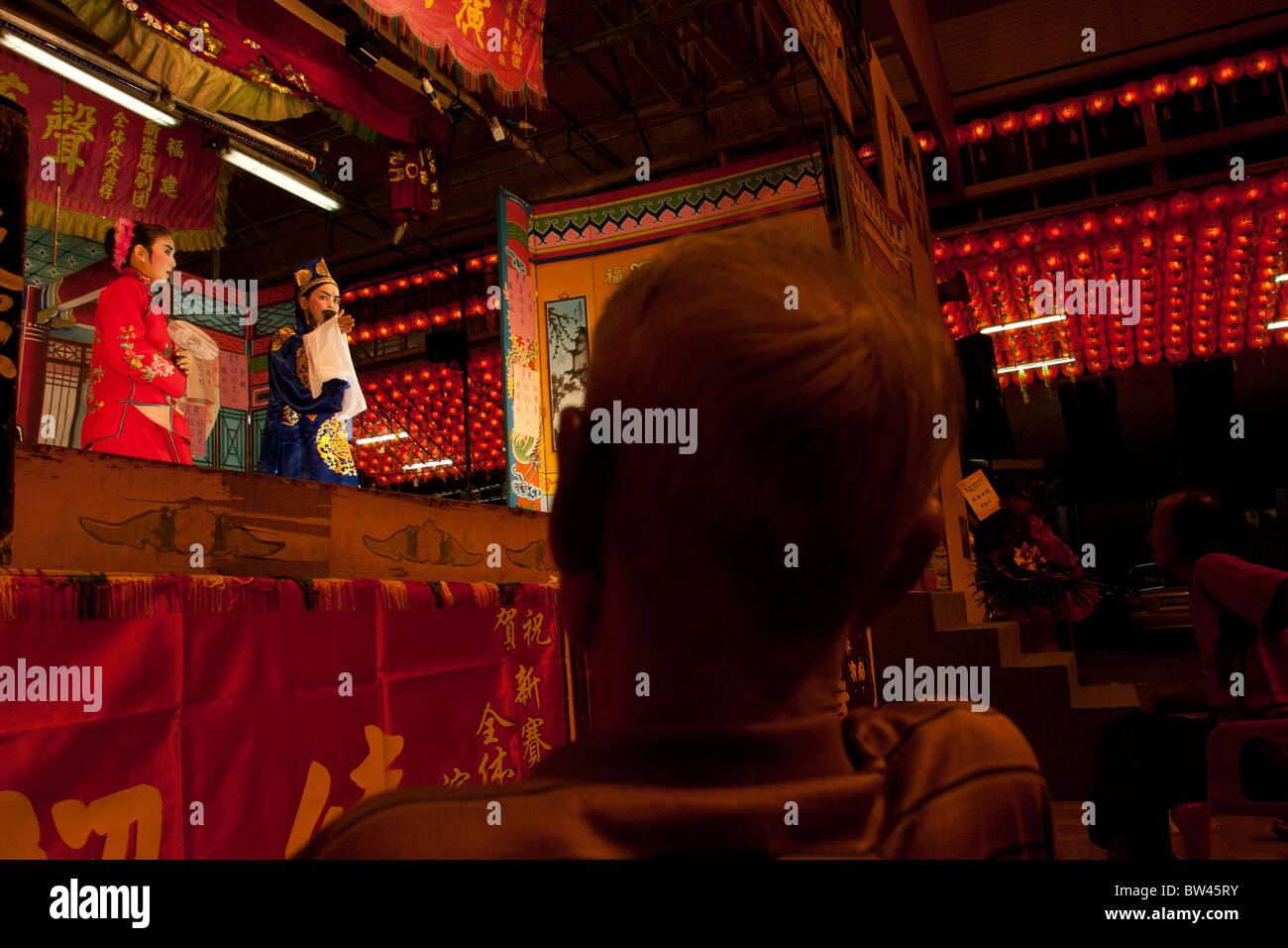 Members of the audience watch a performance by the Sing Sai Hong troupe ...