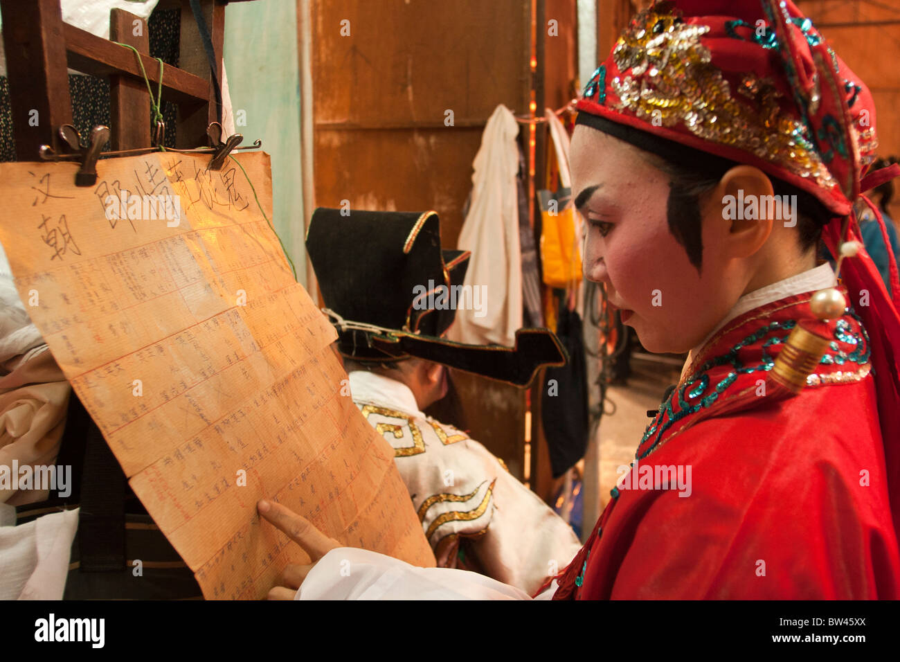 Performers prepare backstage for a performance of the Sing Sai Hong ...