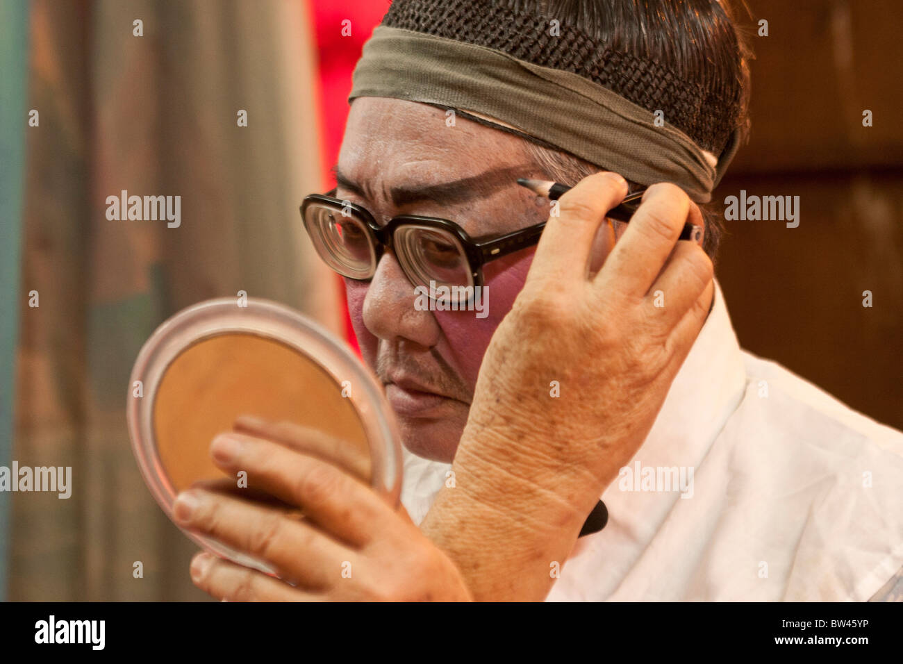 Performers prepare backstage for a performance of the Sing Sai Hong ...