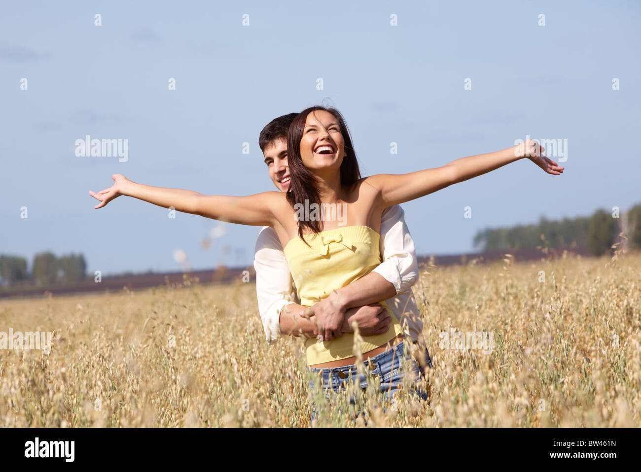 Image of joyful girl stretching arms while being embraced by her ...