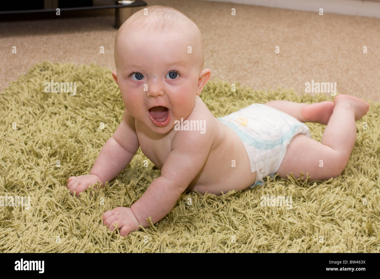 Adorable expressive happy baby boy from low perspective Stock Photo - Alamy