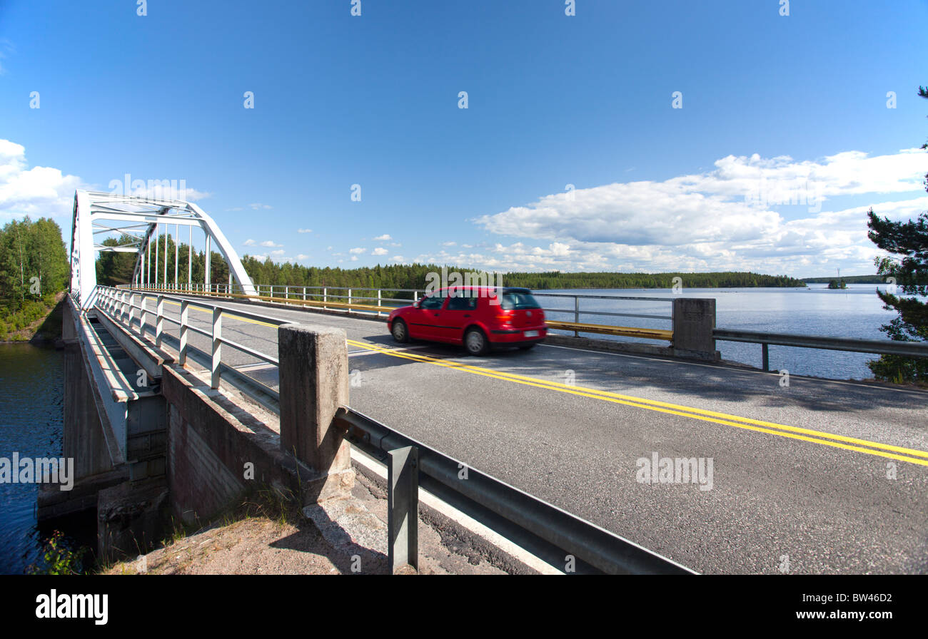 A car crossing a lake strait using a road bridge , Finland Stock Photo ...