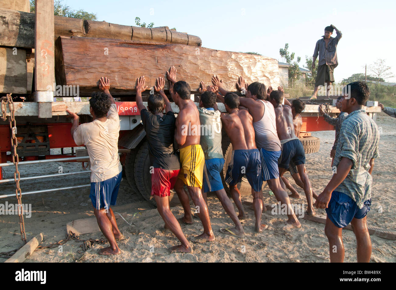 MYANMAR/BURMA. MEN LOADING HARD WOOD TIMBER ONTO LORRY NEAR MANDALAY ON ...