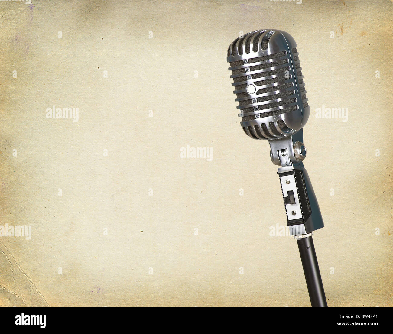 Retro microphone on paper background Stock Photo - Alamy