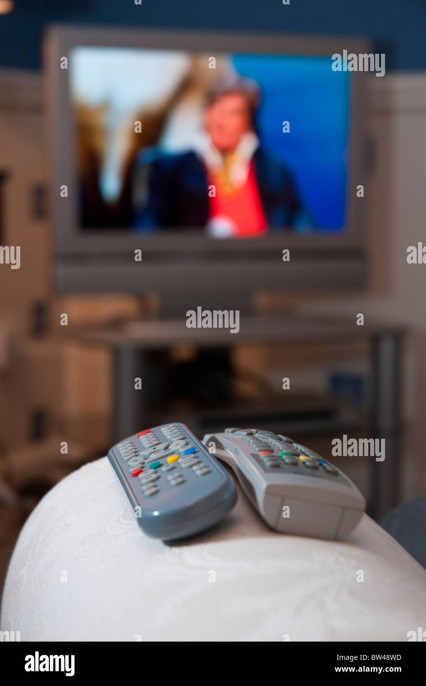 video remote controls for tv sit on the armchair in the sitting room of ...