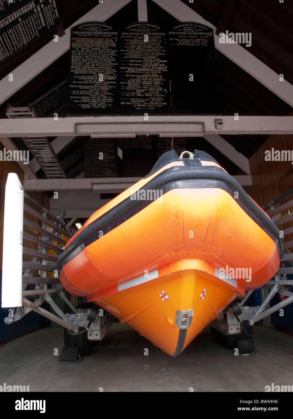 Orange lifeboat stored in a local surf lifesaving club, Staithes, North ...