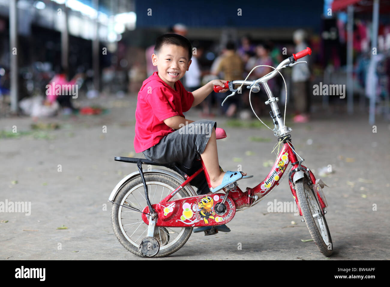 Portrait of a boy on a bicycle in Xishuangbanna, Yunnan, China Stock ...