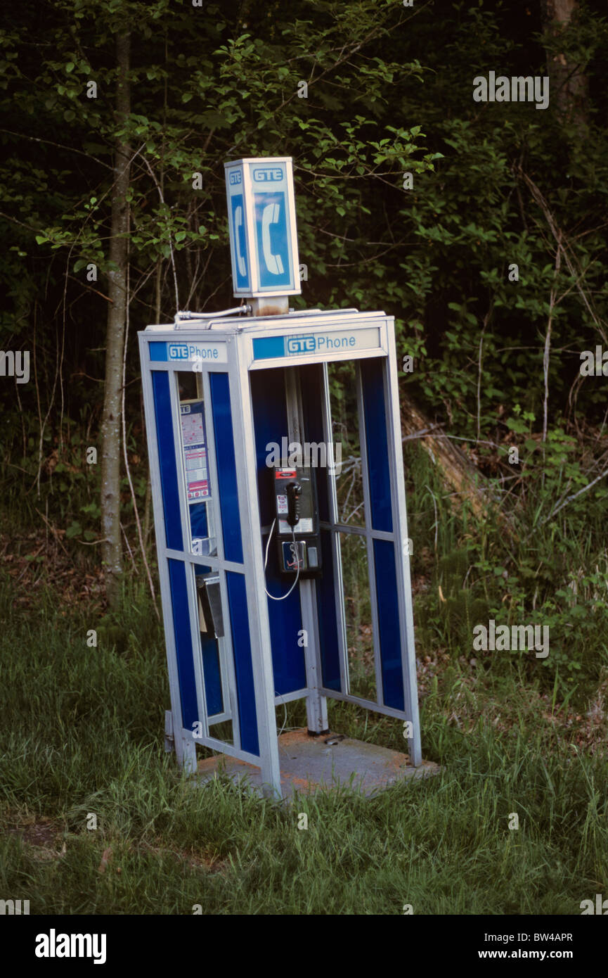 Phone booth abandoned along side of road in grass Stock Photo - Alamy