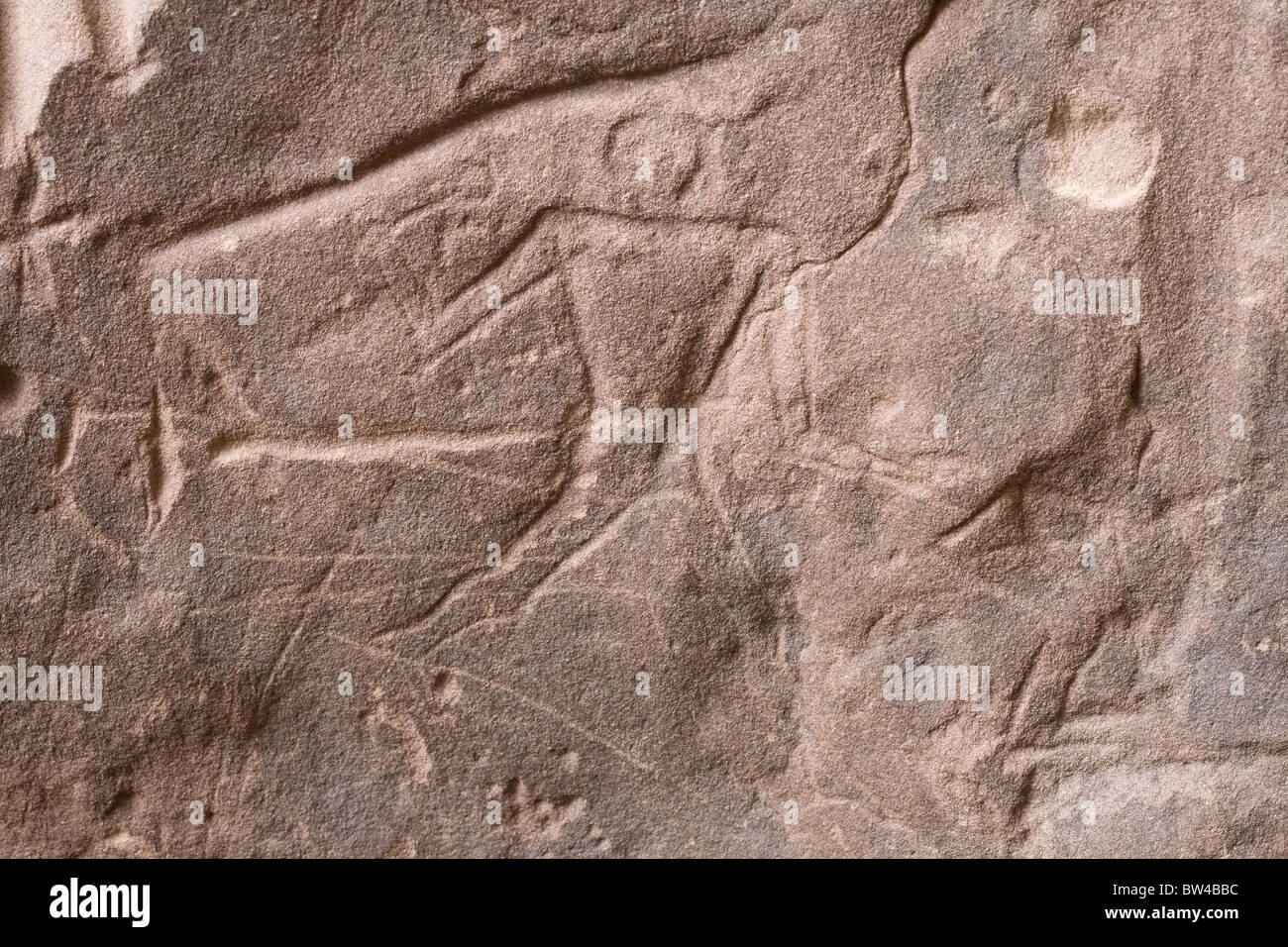 Deep scratched depiction of man holding a round headed mace striding in ...