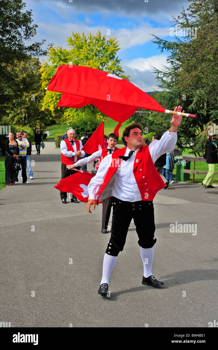 Three Swiss flag throwers performing at a festival of folklore Stock ...