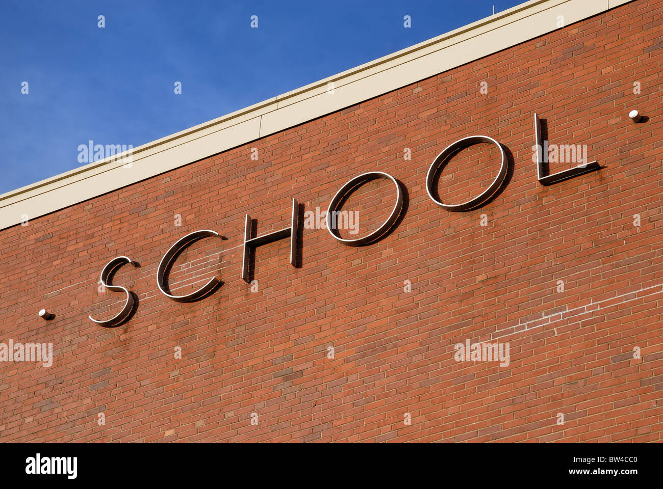The word "school" on the side of a school building Stock Photo - Alamy