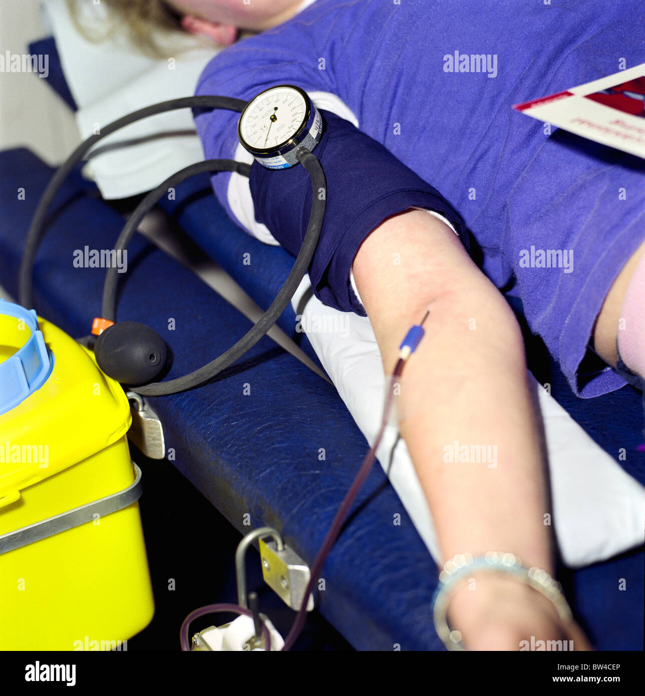 Blood donor with needle in arm Stock Photo - Alamy