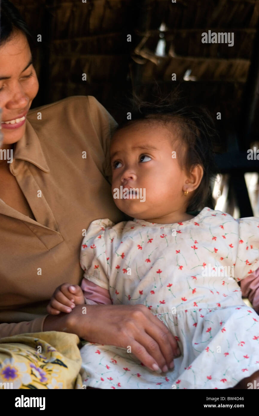 A baby girl born into poverty looks at her mother's face in a slum in ...