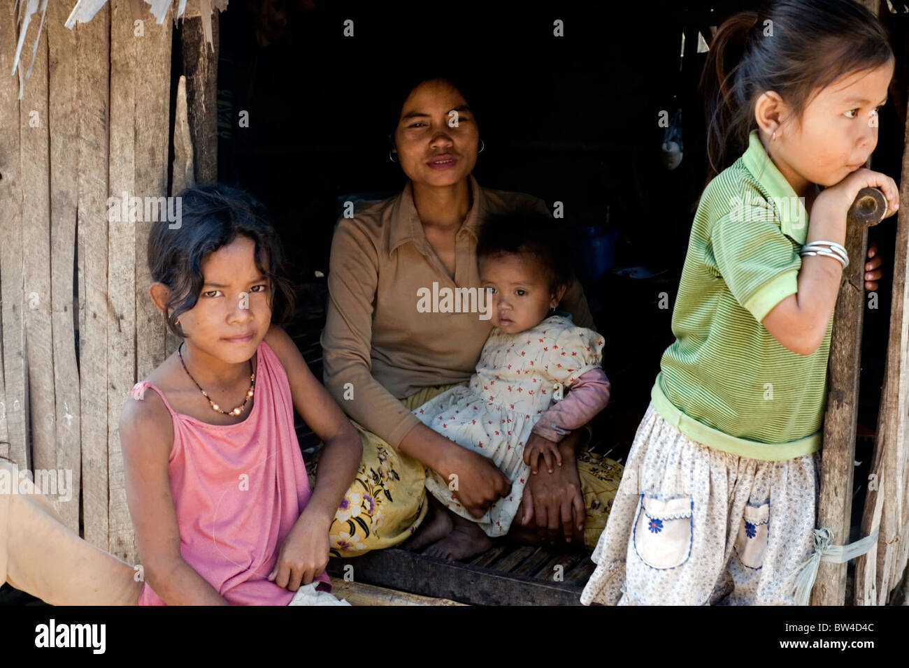 A group of female slum dwellers are living in poverty in a wood shack ...