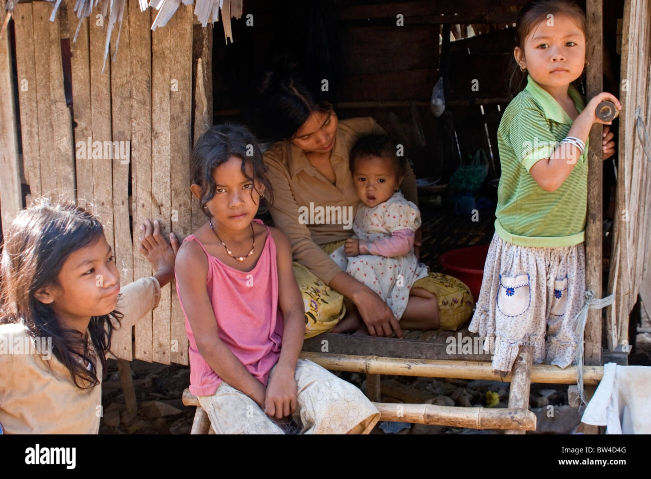 A group of female slum dwellers are living in poverty in a wood shack ...