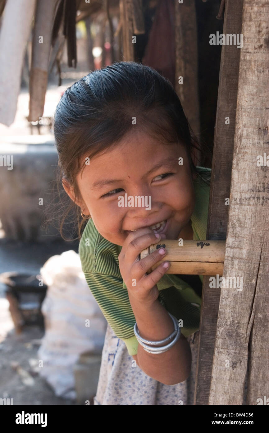 A young girl living in poverty is having fun playing at her home in ...