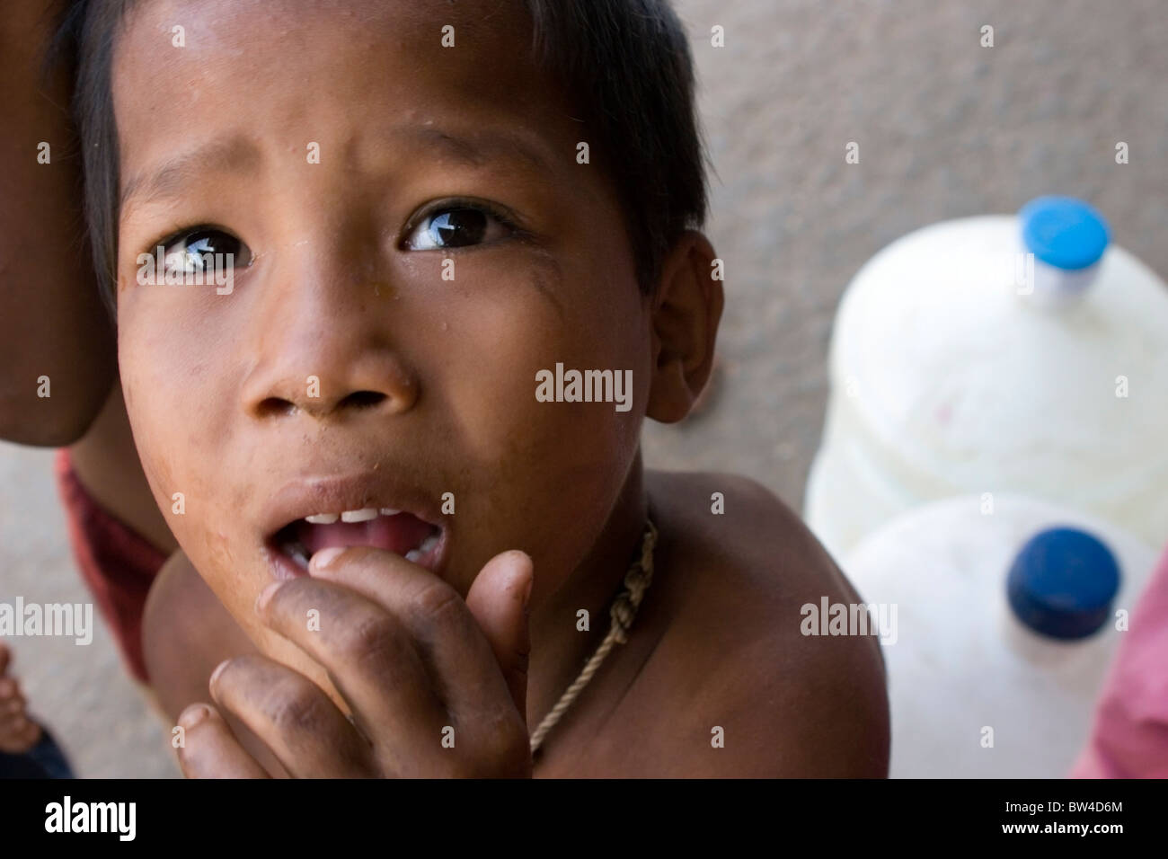 A hungry street child boy is in need of food on the streets of Kampong ...