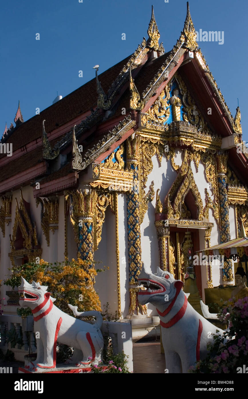 A bright Buddhist temple decorated with ornate designs is part of the ...