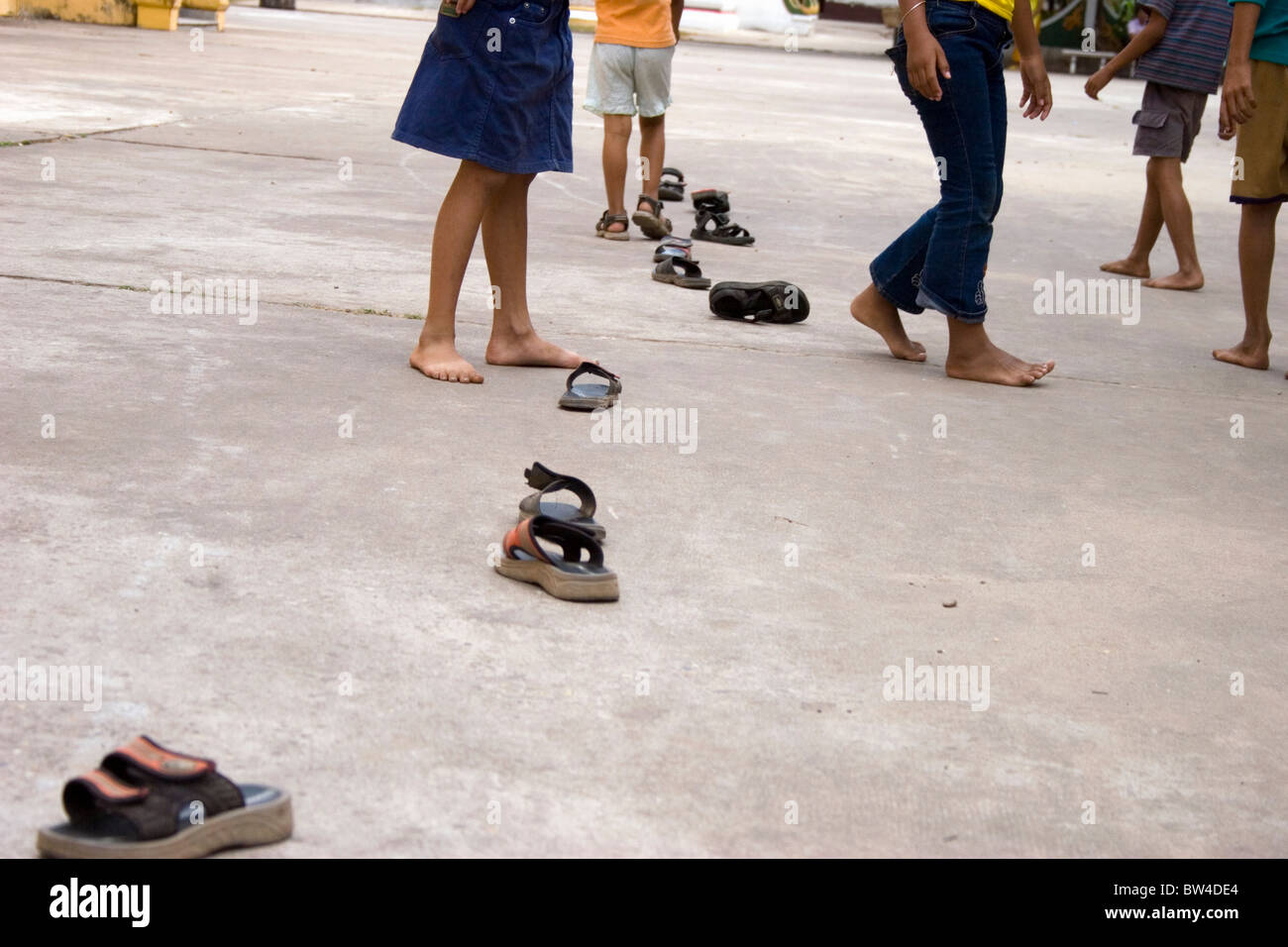 A group of young children are playing a traditional street game with ...