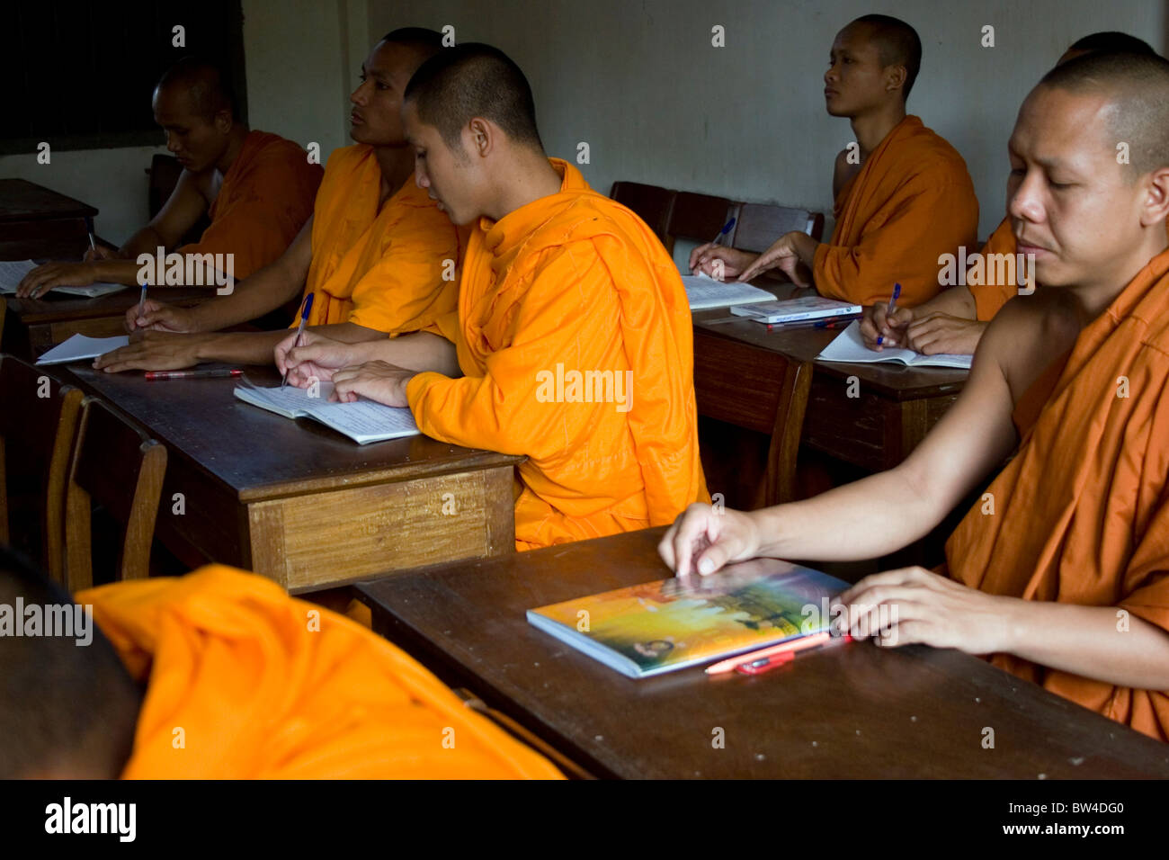 Buddhist monks are studying in a classroom during a high school class ...