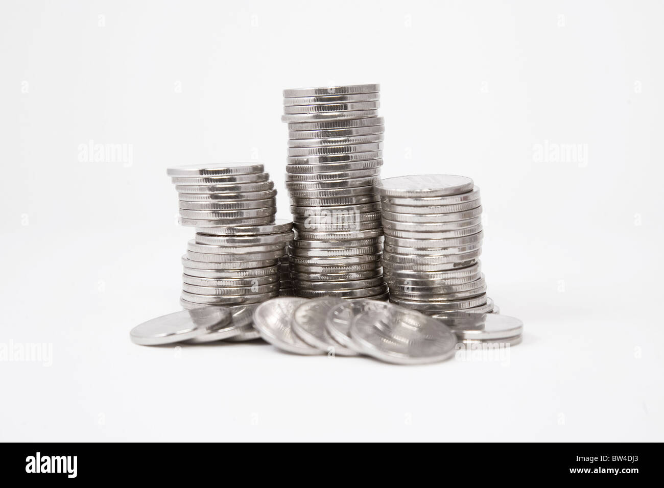 Stacks of silver coins on white background Stock Photo - Alamy
