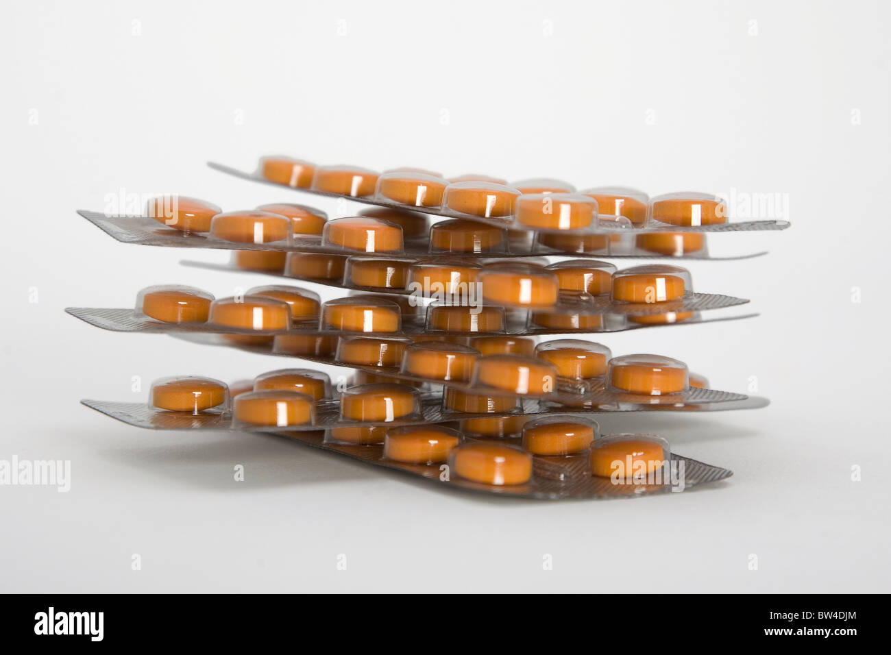 Packs of orange pills isolated on white background Stock Photo - Alamy