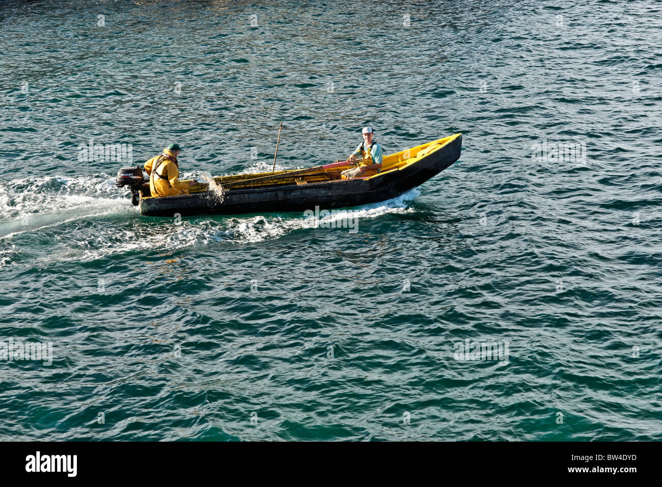 Two inshore fishermen in a currach boat, Inis Meain, Aran Islands ...