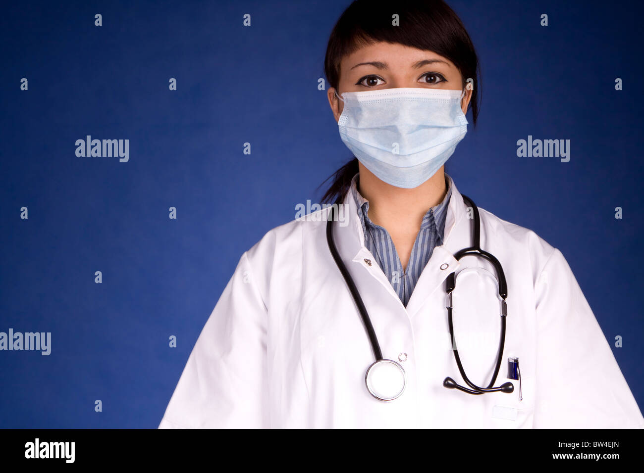 Woman Doctor Wearing A Mask Examining You Stock Photo - Alamy