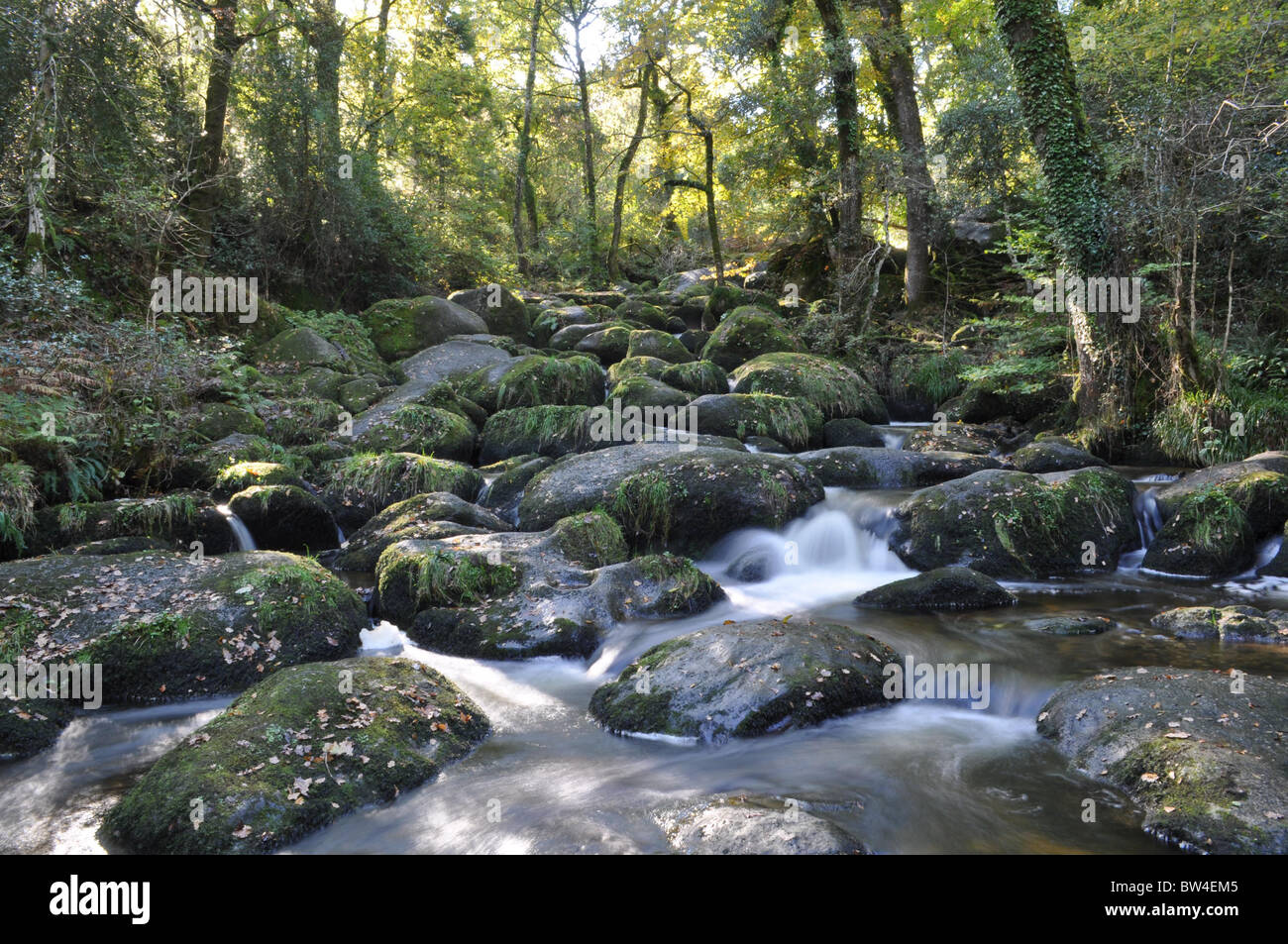 Water flowing between the rocks and dappled with sunlight, at Becky ...
