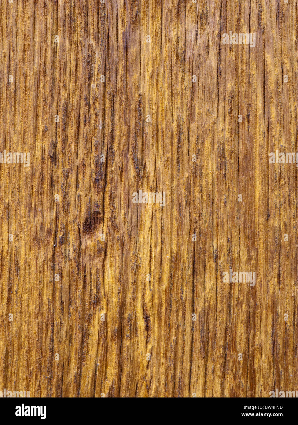 Worn old yellow brown wood with remains of tar paint, background or ...