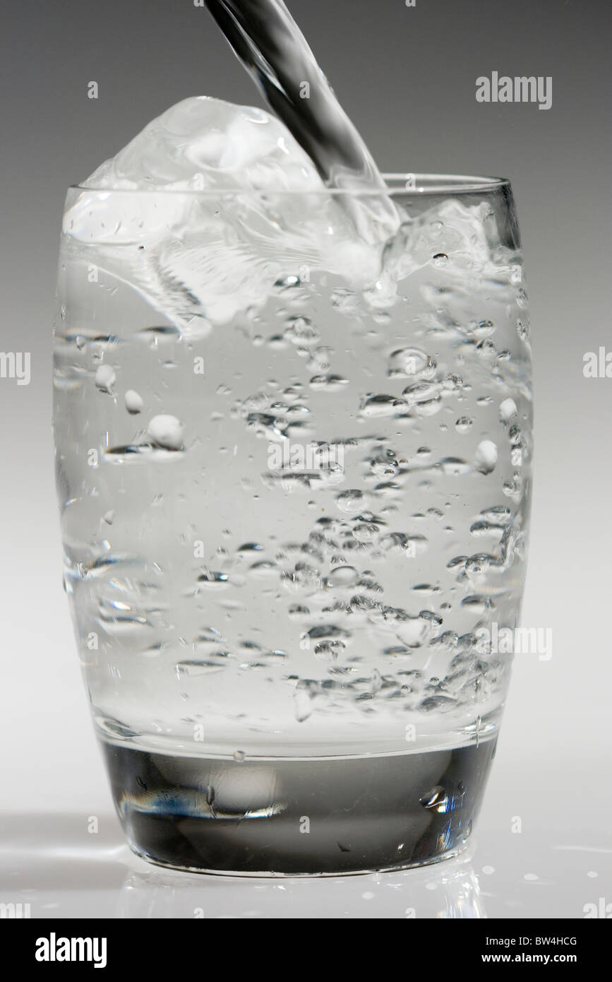 Mineral water stream pouring into a clean transparent glass Stock Photo ...