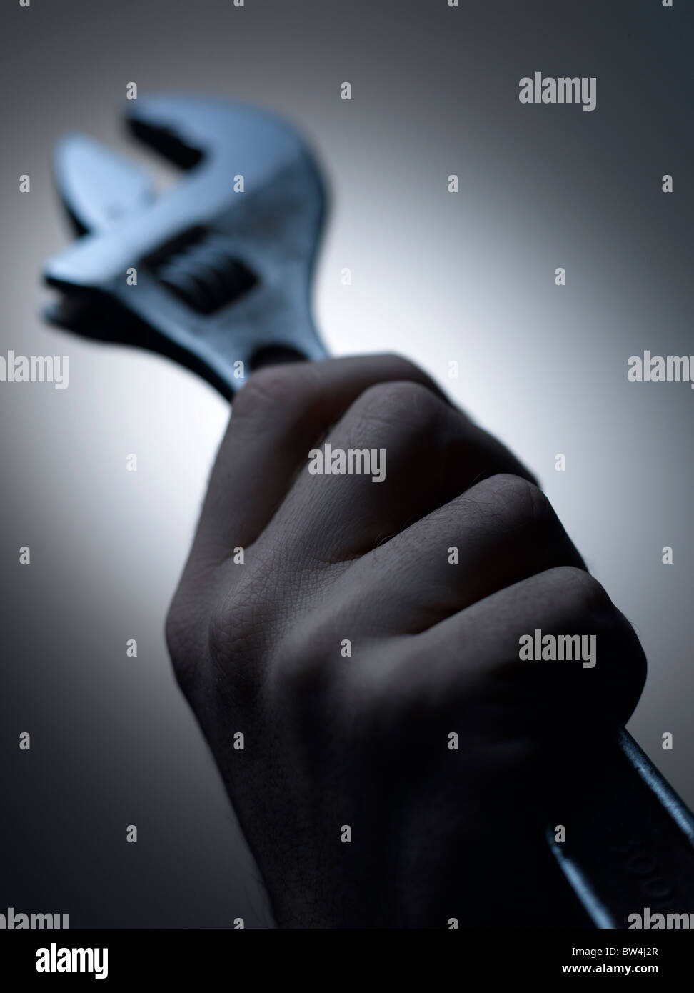 Hand holding spanner Stock Photo - Alamy