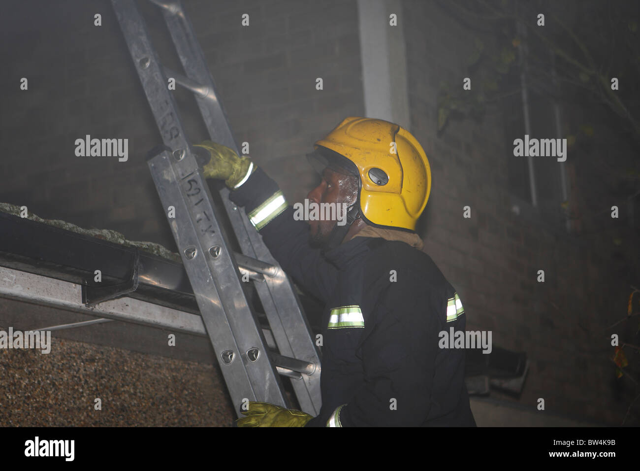 Fireman climbing a ladder Stock Photo - Alamy