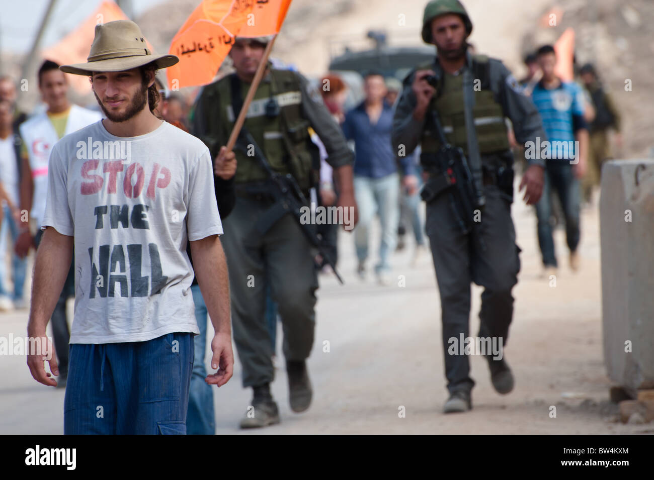 An Israeli activist wearing a shirt with the slogan "Stop the Wall ...
