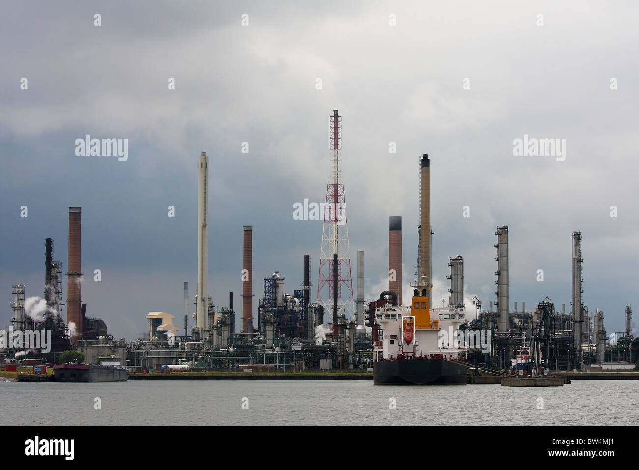 Refinery in Antwerp with ship Stock Photo - Alamy