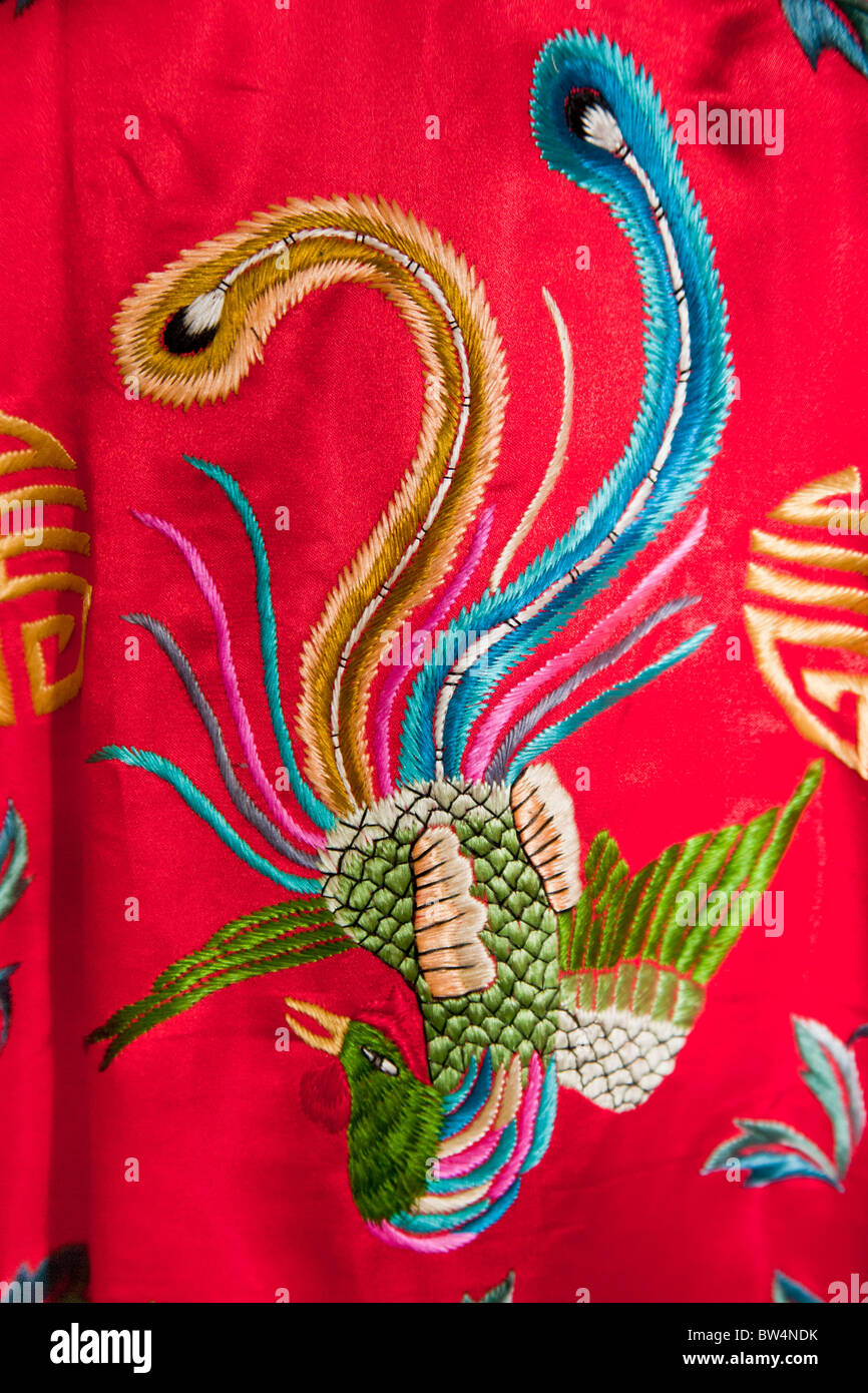 Colourful red Chinese embroidered silk garment depicting a phoenix bird ...