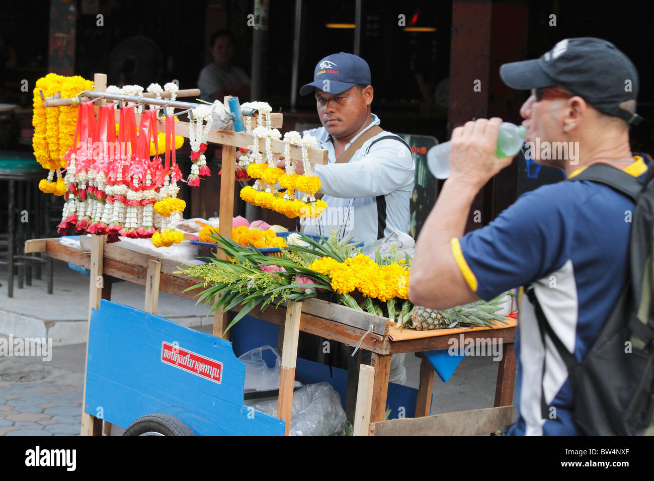 Thai flower man street vendor selling flowery necklaces & pendants ...