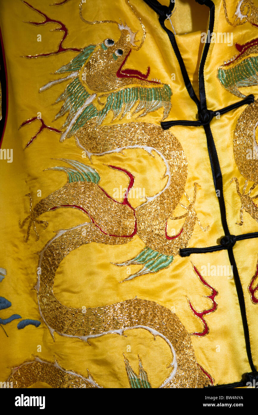 Colourful yellow Chinese embroidered silk garment depicting a dragon ...