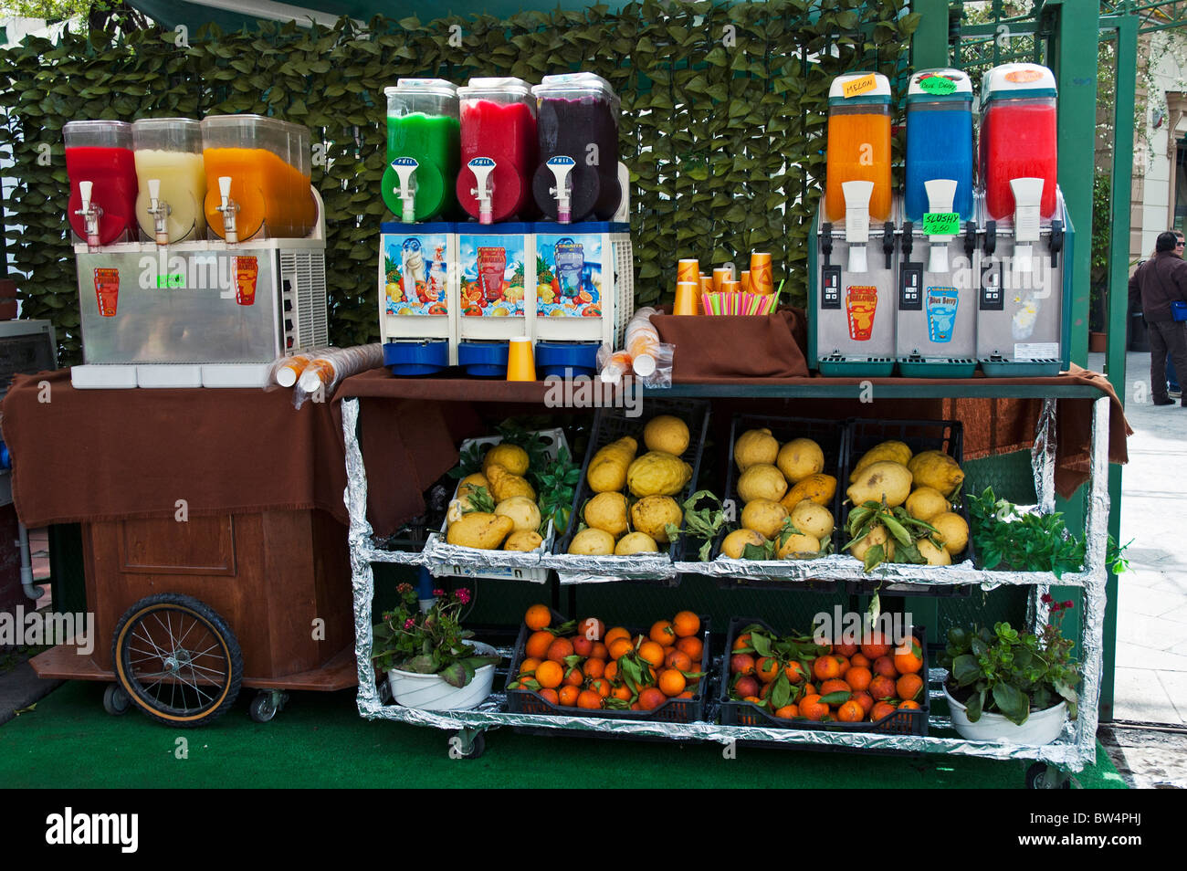 Colourful cold fruit drinks tastefully arranged behind a hedge of ...