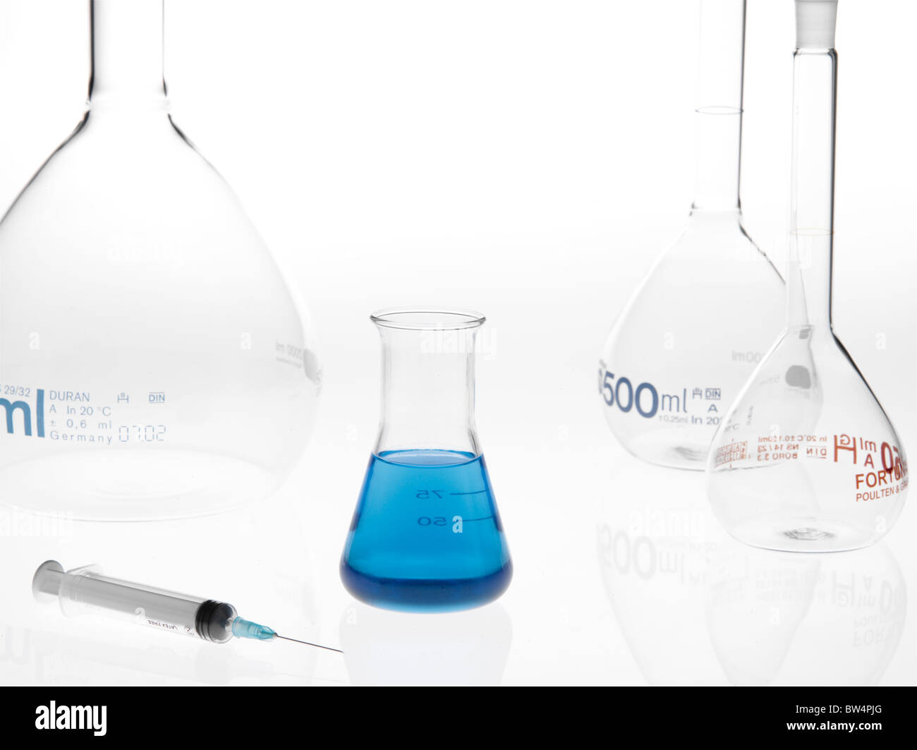 Chemical flasks over white background Stock Photo - Alamy
