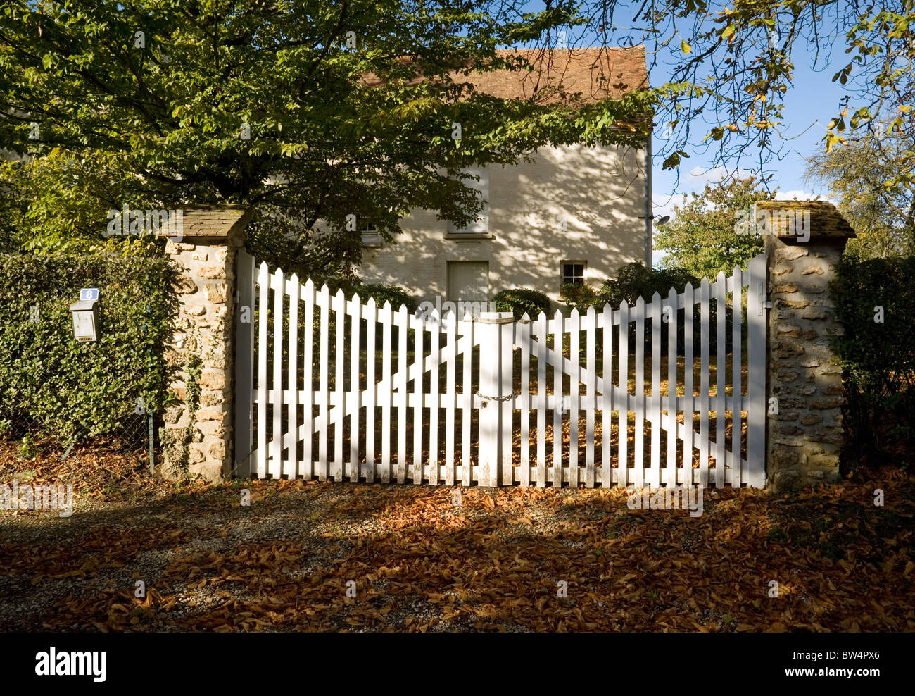 Closed white wooden gates to a french farmhouse, St Simeon Village, Ile ...