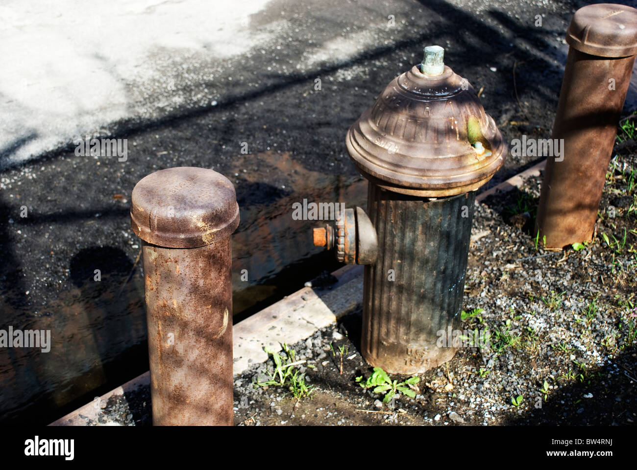 Street side fire hydrant protected by pipes on each side of it Stock ...